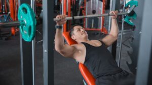 Smith Machine Bench Press: Muscles Worked, How To Do, Tips